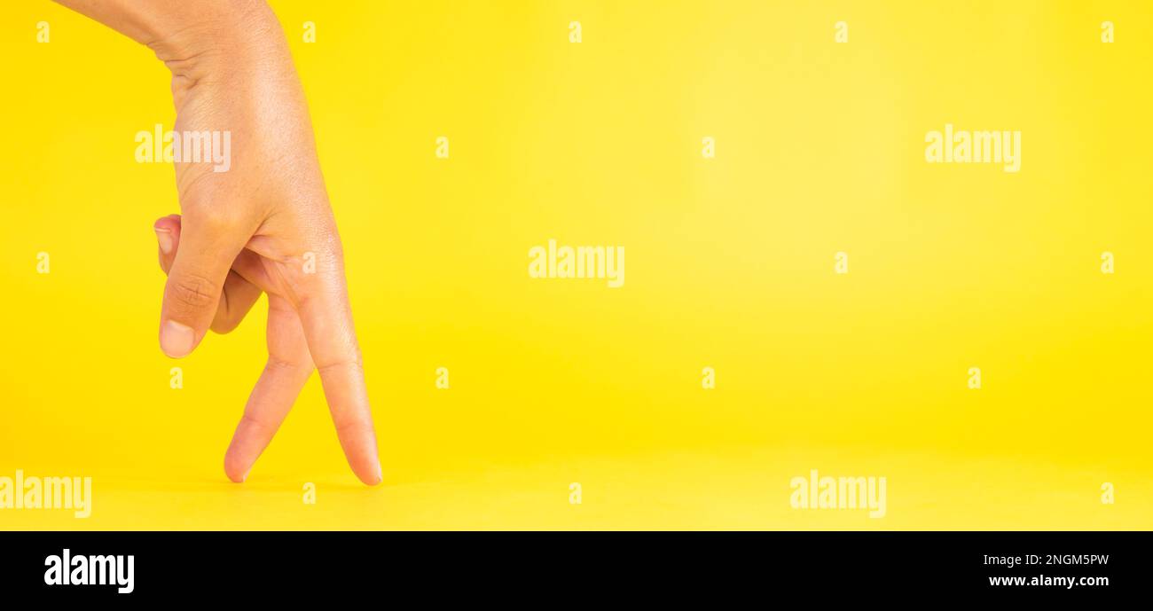 A woman's hand, imitating legs with fingers, humorously, like walking ...