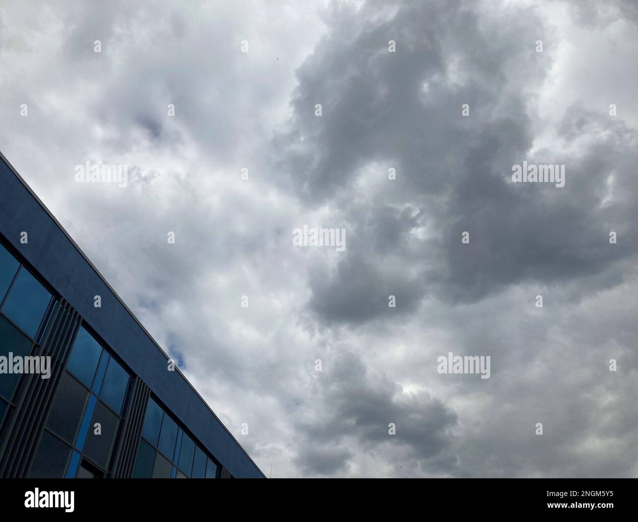 Sky and clouds reflection in the windows of modern skyscraper. Overcast ...