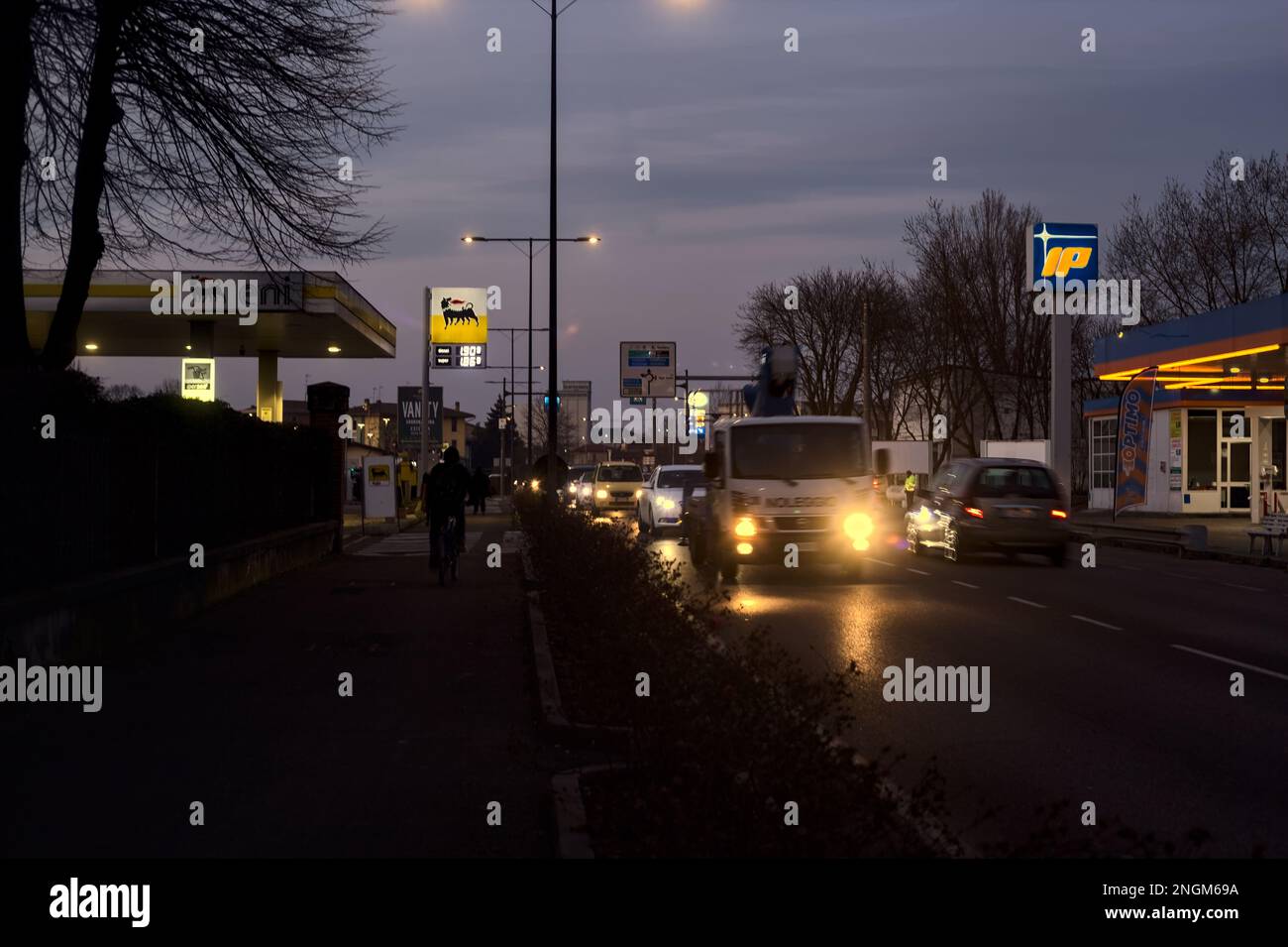 Road at dusk with cars passing by and gas stations at its edge Stock ...