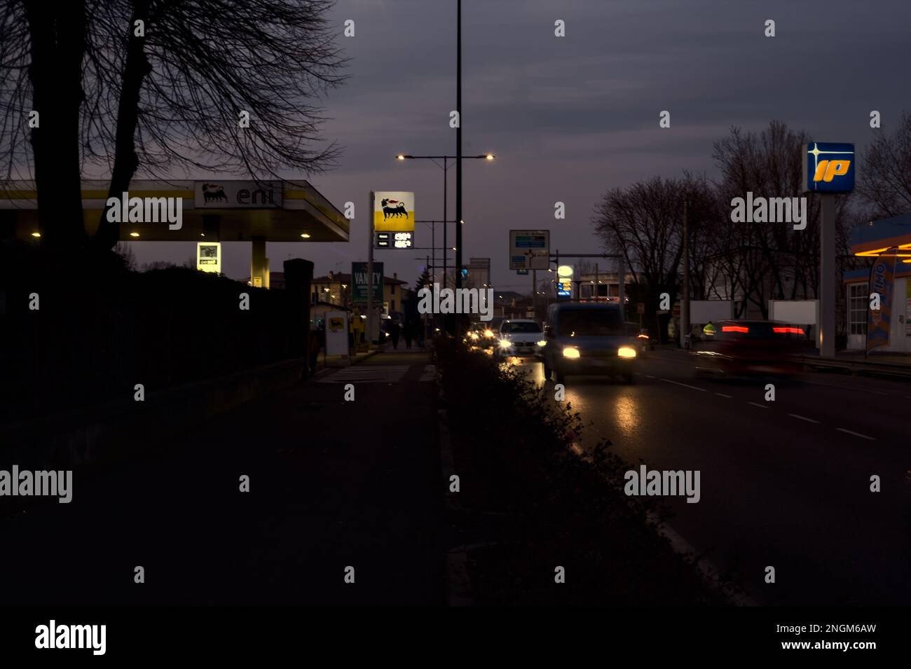 Road at dusk with cars passing by and gas stations at its edge Stock ...