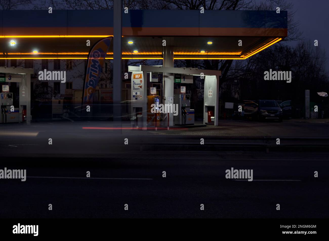 Road at dusk with cars passing by and gas stations at its edge Stock ...