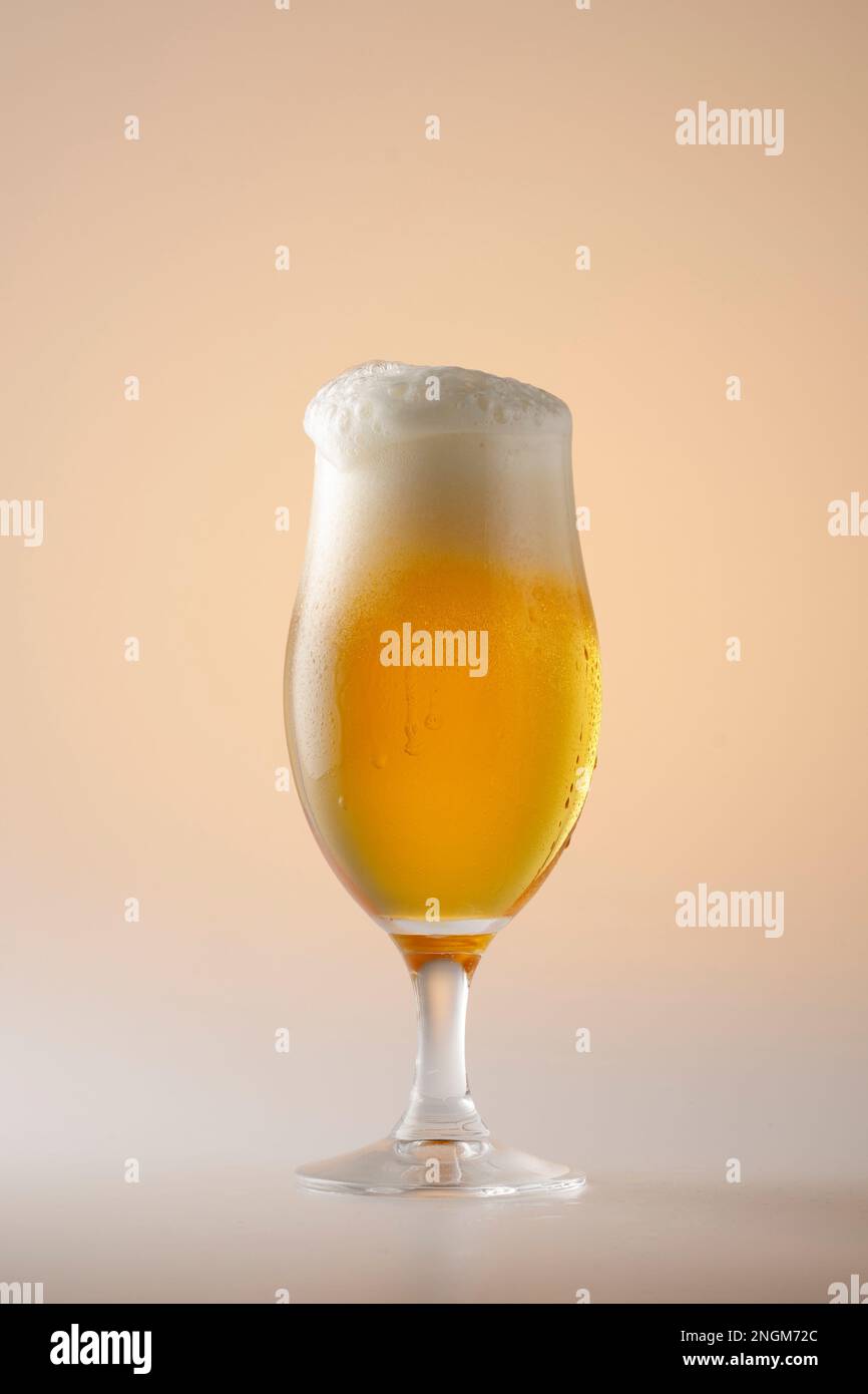 Beer in a glass with foam Stock Photo - Alamy