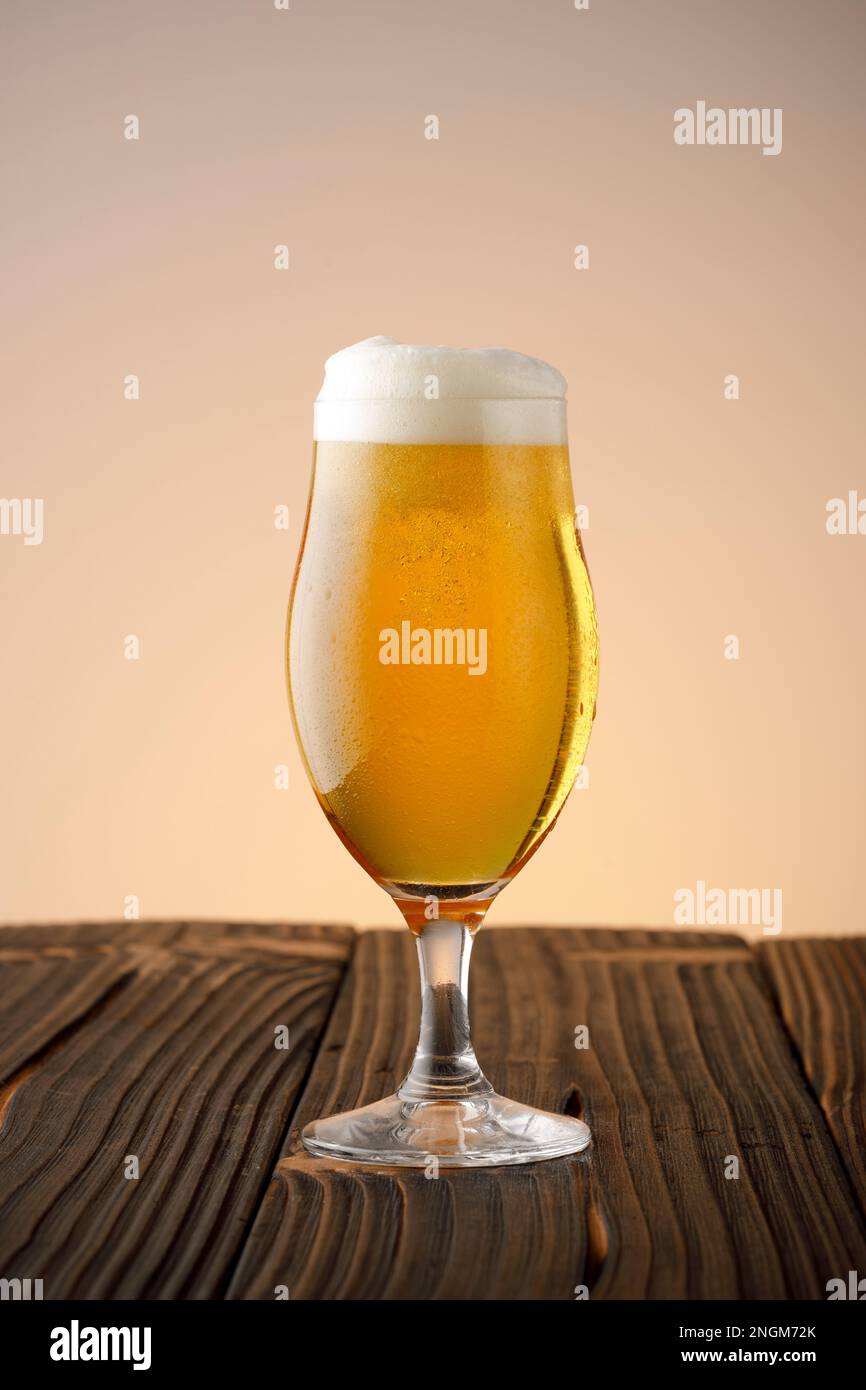 Beer in a glass with foam Stock Photo - Alamy