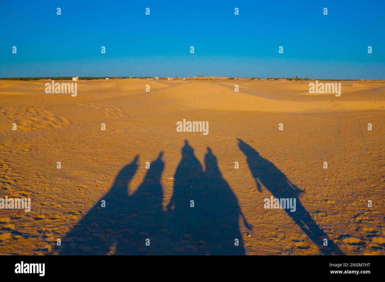 Shadows of 5 men on the sand in Sahara desert in Tunisia Stock Photo ...