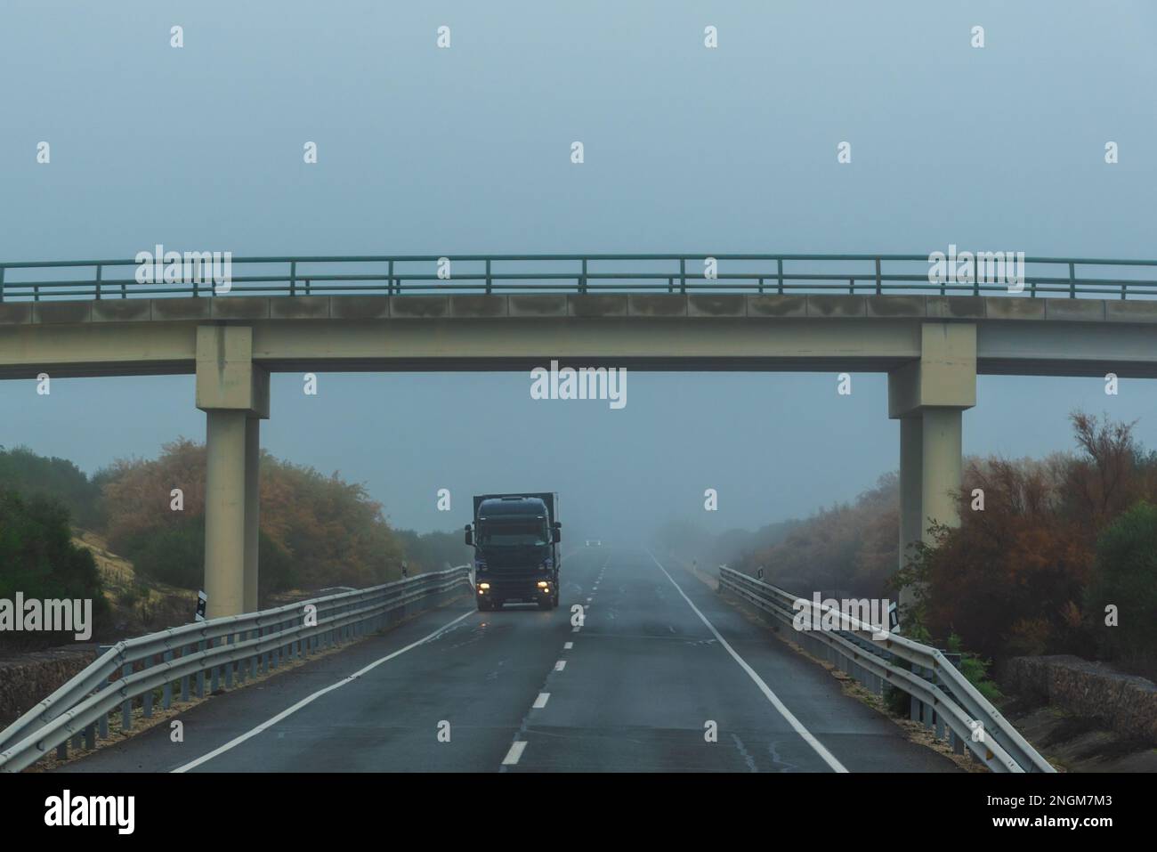 Truck driving on a conventional two-way highway on a foggy day Stock ...