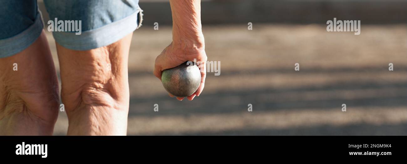 Senior playing petanque un and relaxing game. Senior woman prepared to ...