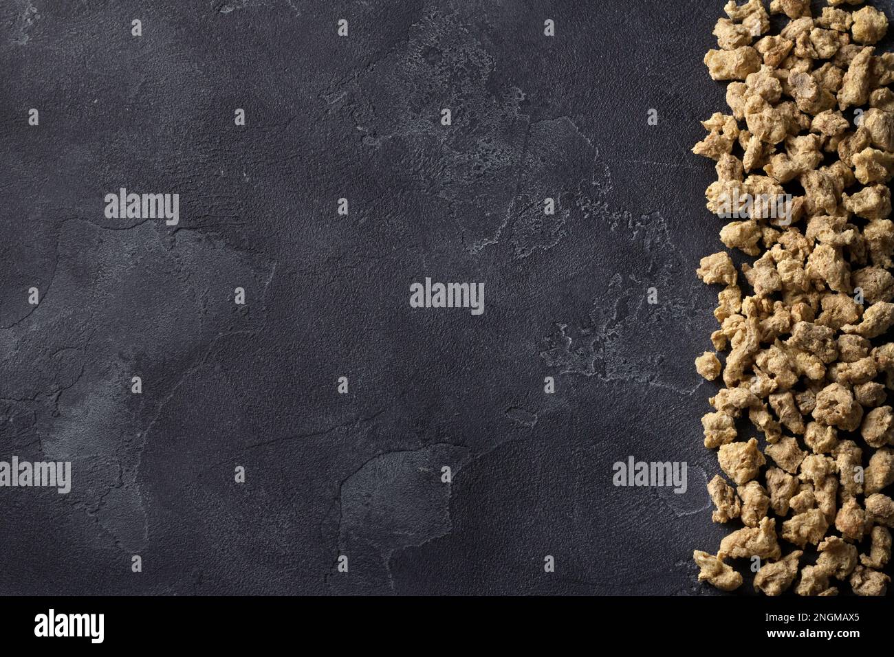 Dried soy meat on black textured background, top view, free space Stock ...