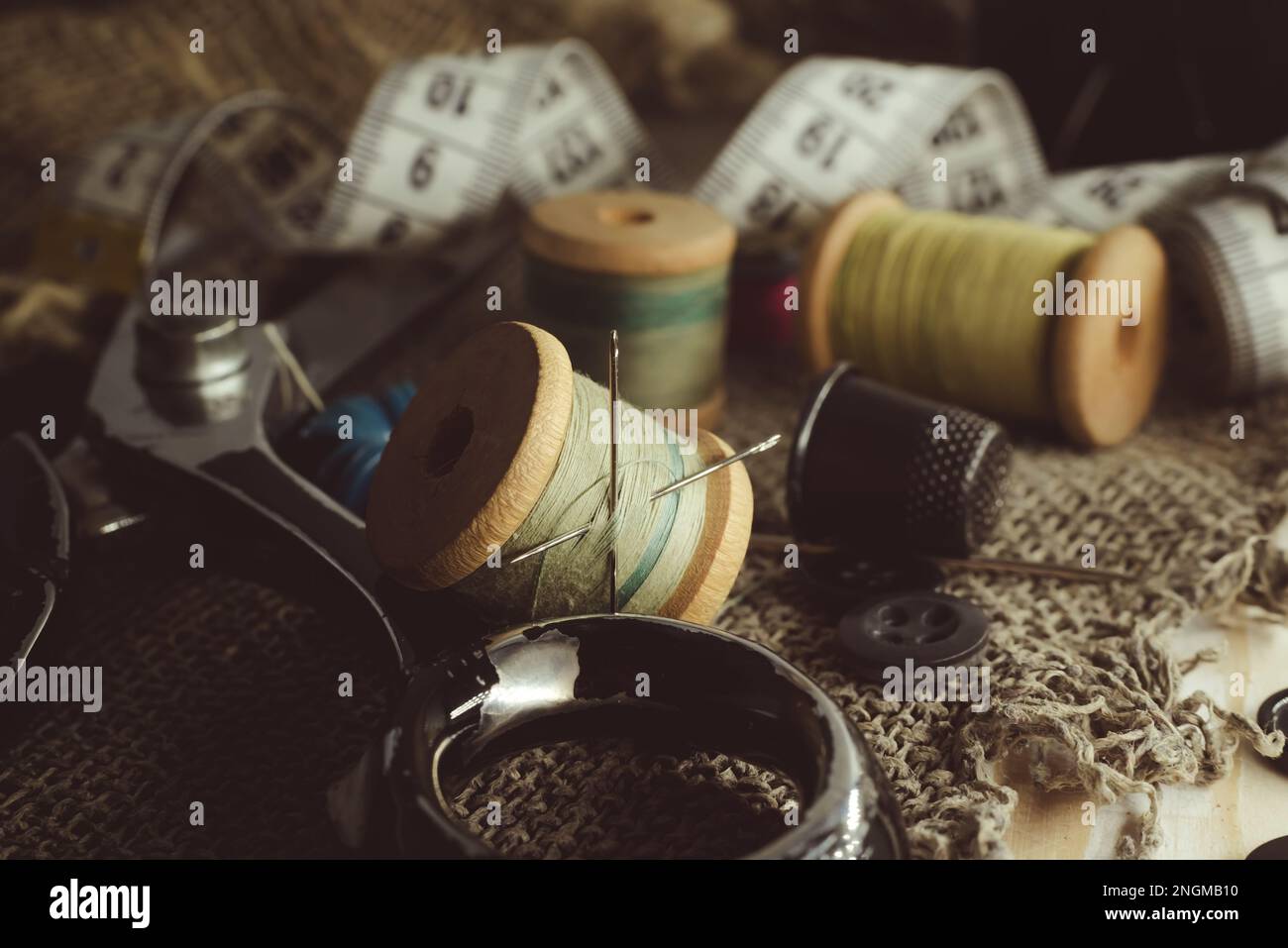 Retro tools for cutting and sewing. Needle with thread, thimble, sewing ...