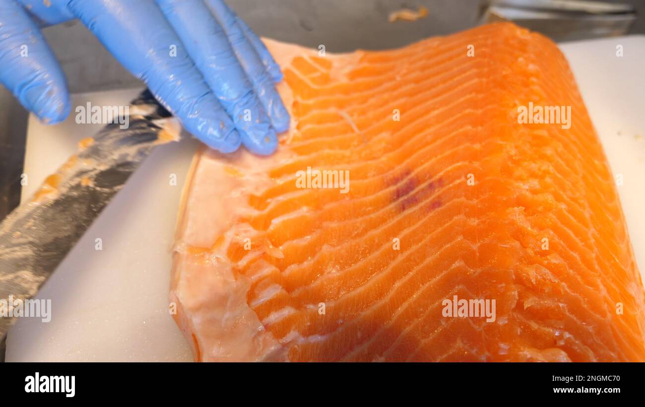 Cutting fresh wild Norwegian salmon fish in store Stock Photo - Alamy
