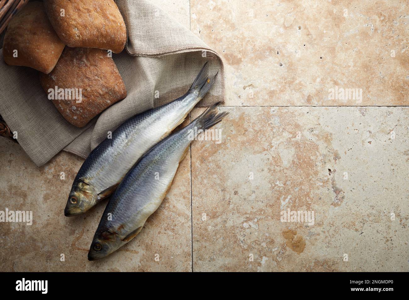 Christianity background. Loaves of bread and two fish in a basket Stock ...
