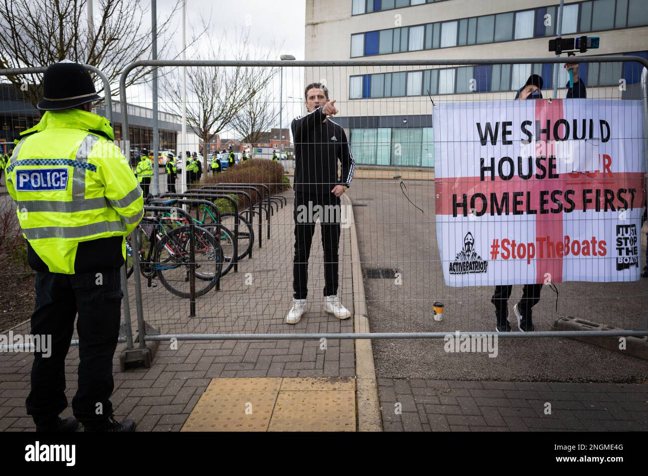 Rotherham, UK. 18th Feb, 2023. A anti-immigration demonstrator points ...