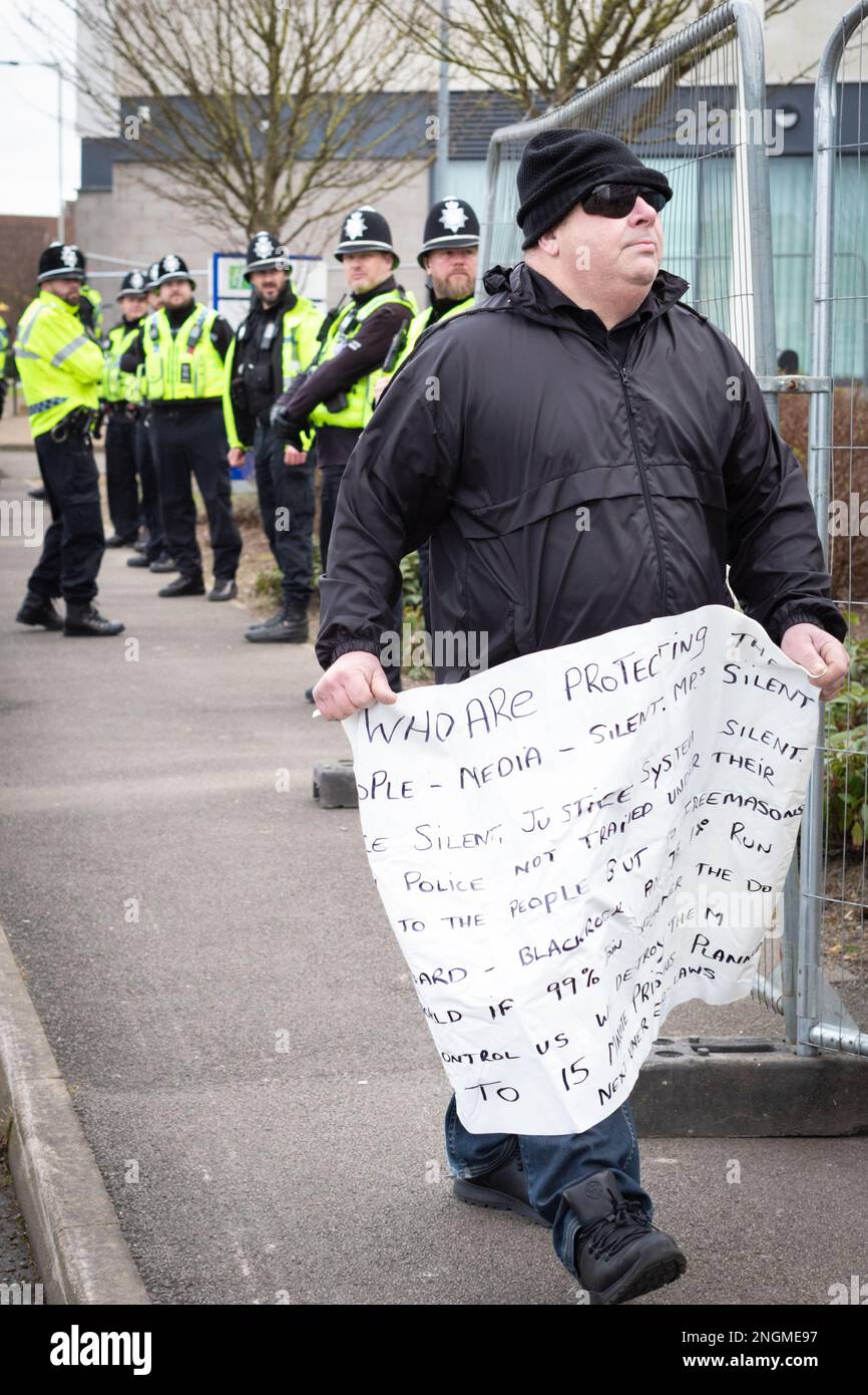 Rotherham, UK. 18th Feb, 2023. An anti-immigration demonstrator walks ...