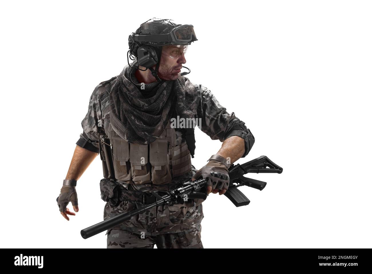 A mercenary soldier walks with an automatic rifle in his hand and looks ...