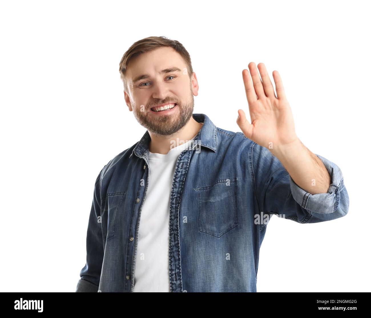 Happy young man waving to say hello on white background Stock Photo - Alamy