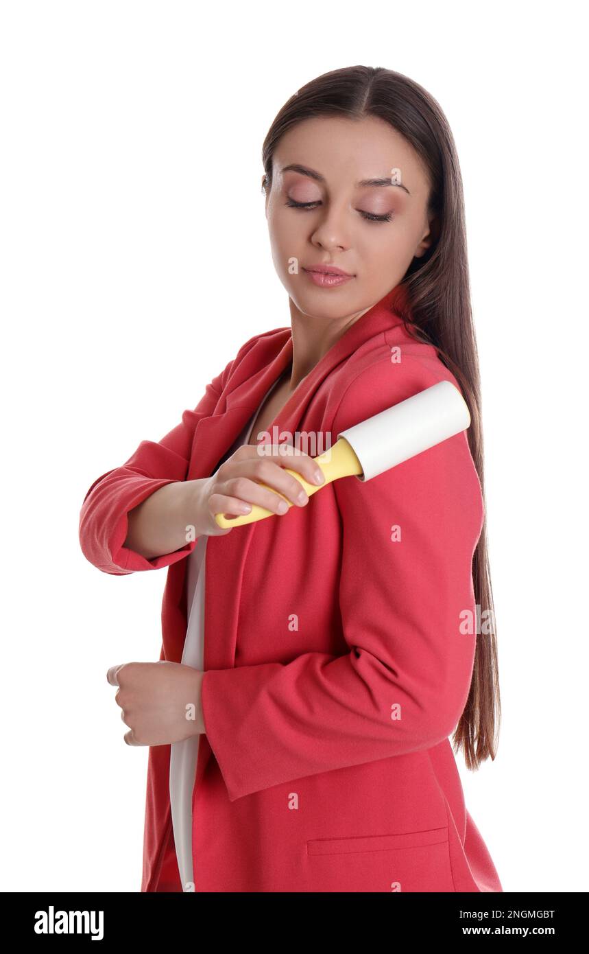 Young woman cleaning clothes with lint roller on white background Stock ...