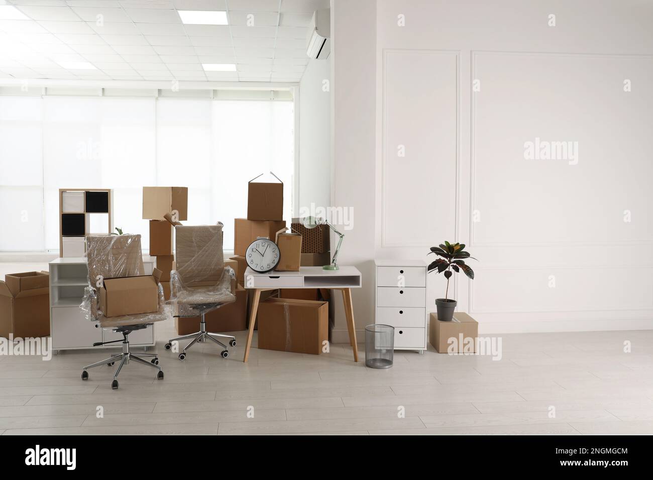 Cardboard boxes and packed stuff in office. Moving day Stock Photo - Alamy