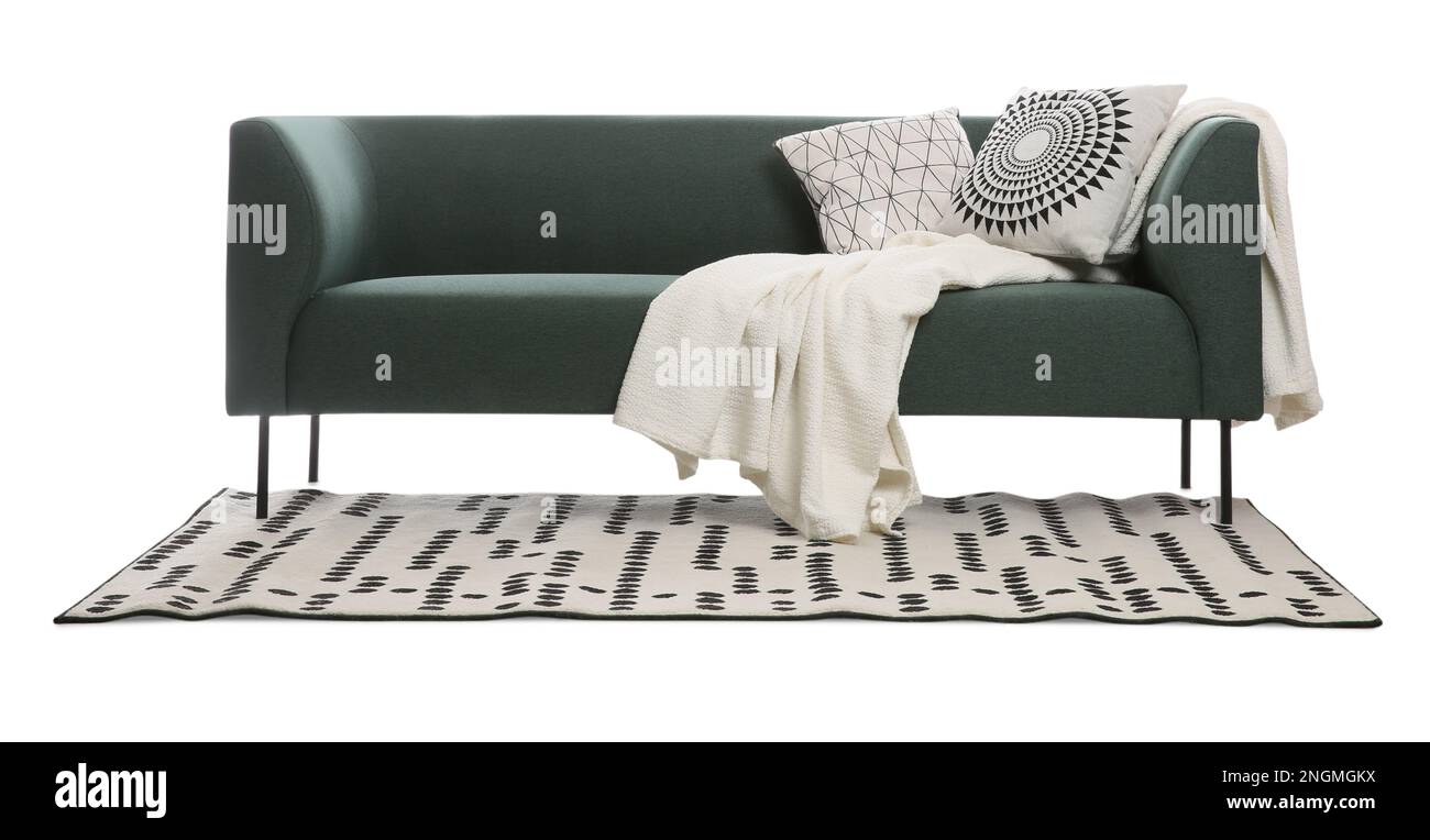 Comfortable green sofa with cushions, blanket and carpet on white ...
