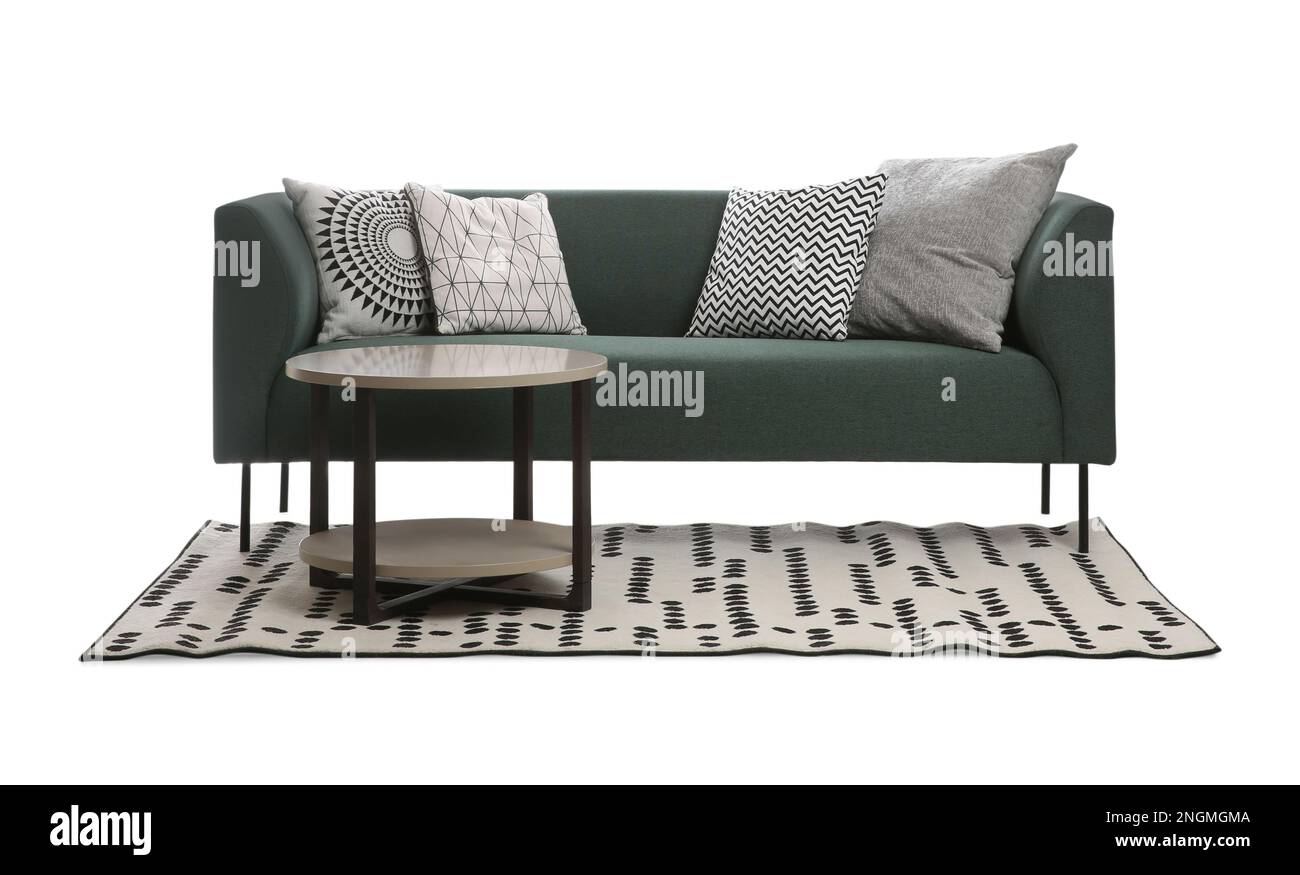 Comfortable green sofa with cushions, table and carpet on white ...
