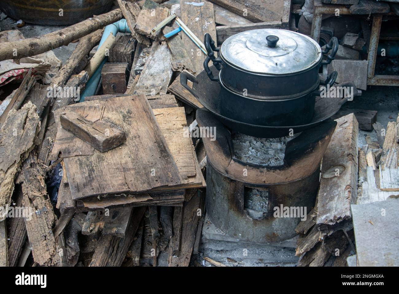 Traditional outdoor fire pit with dishware and wood in the backyard of ...