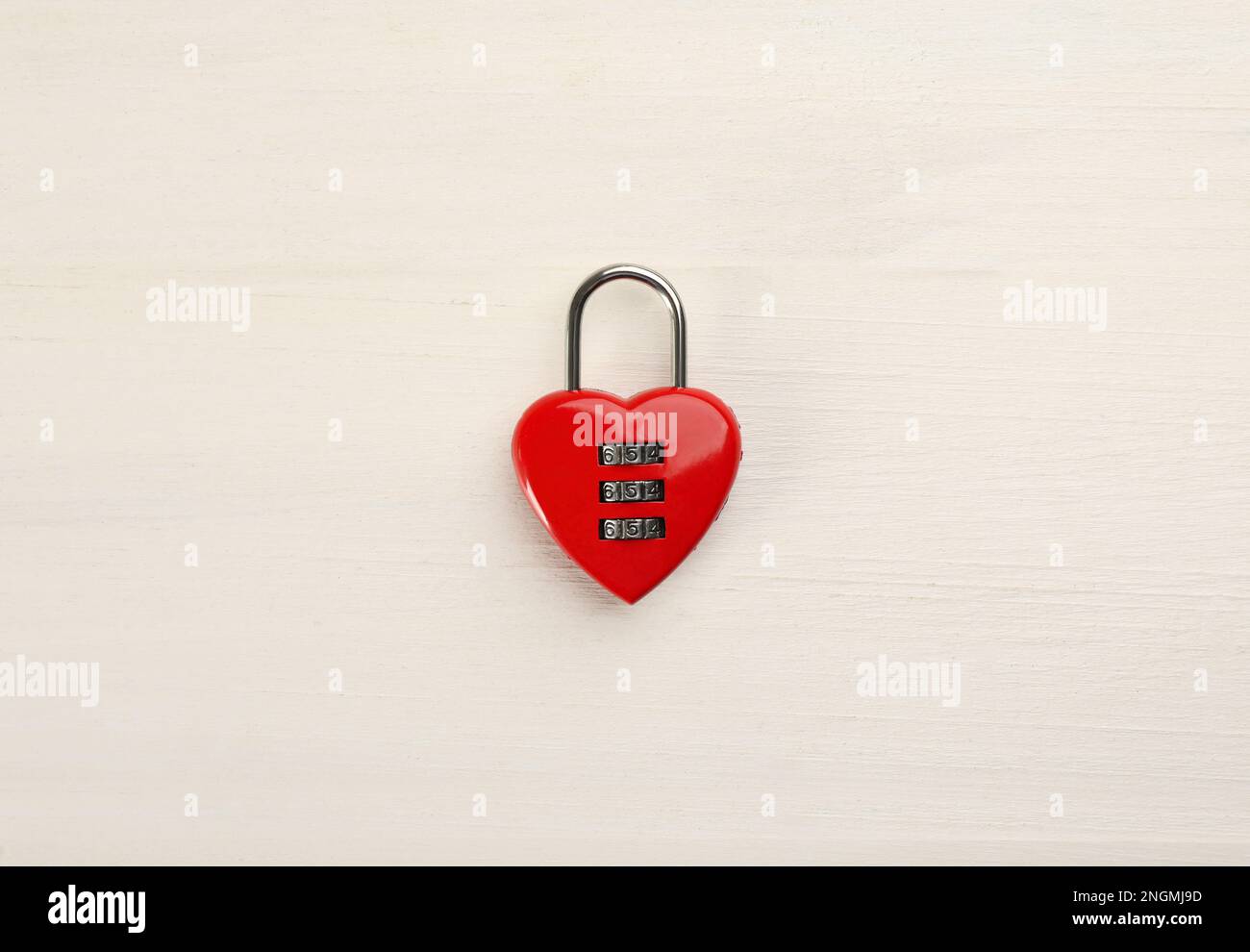 Red heart shaped combination lock on white wooden table, top view Stock ...