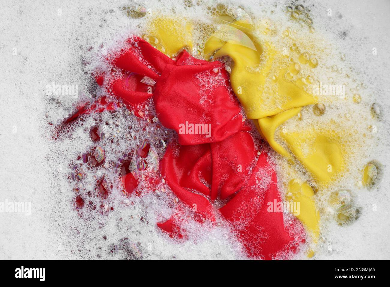 Color clothing in suds, top view. Hand washing laundry Stock Photo - Alamy