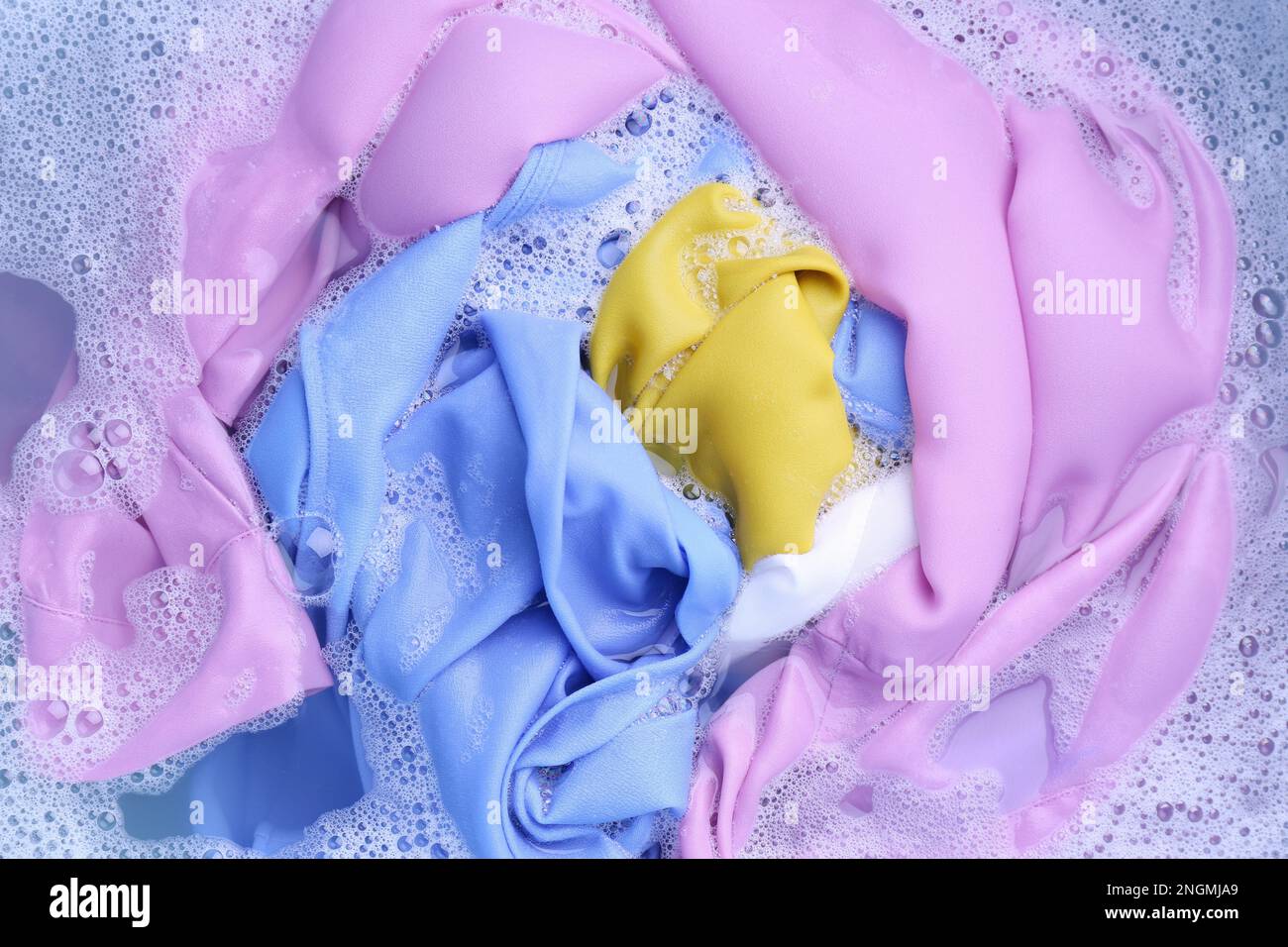Color clothing in suds, top view. Hand washing laundry Stock Photo - Alamy