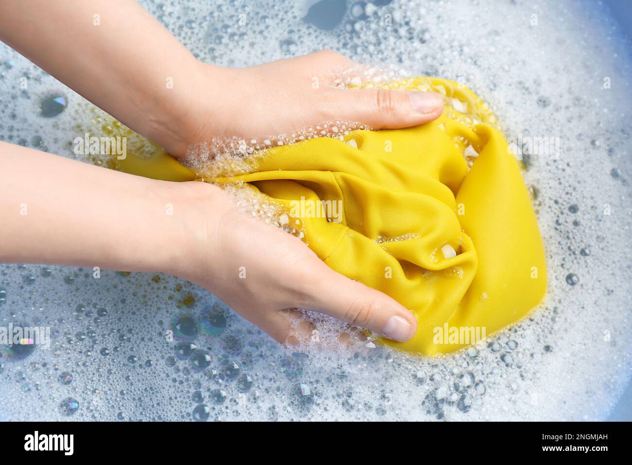 Top view of woman hand washing color clothing in suds, closeup Stock ...