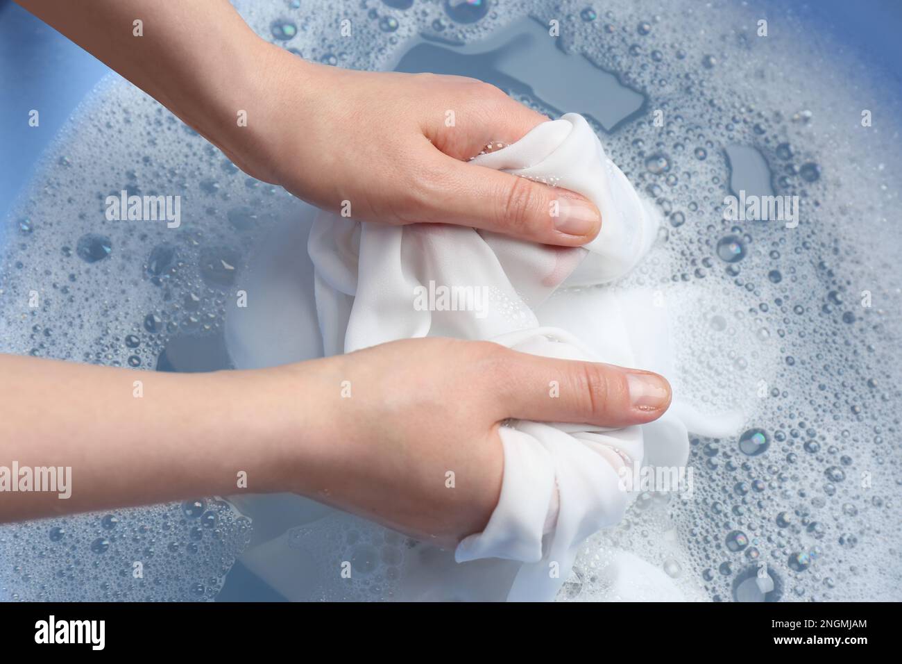Top view of woman hand washing white clothing in suds, closeup Stock ...