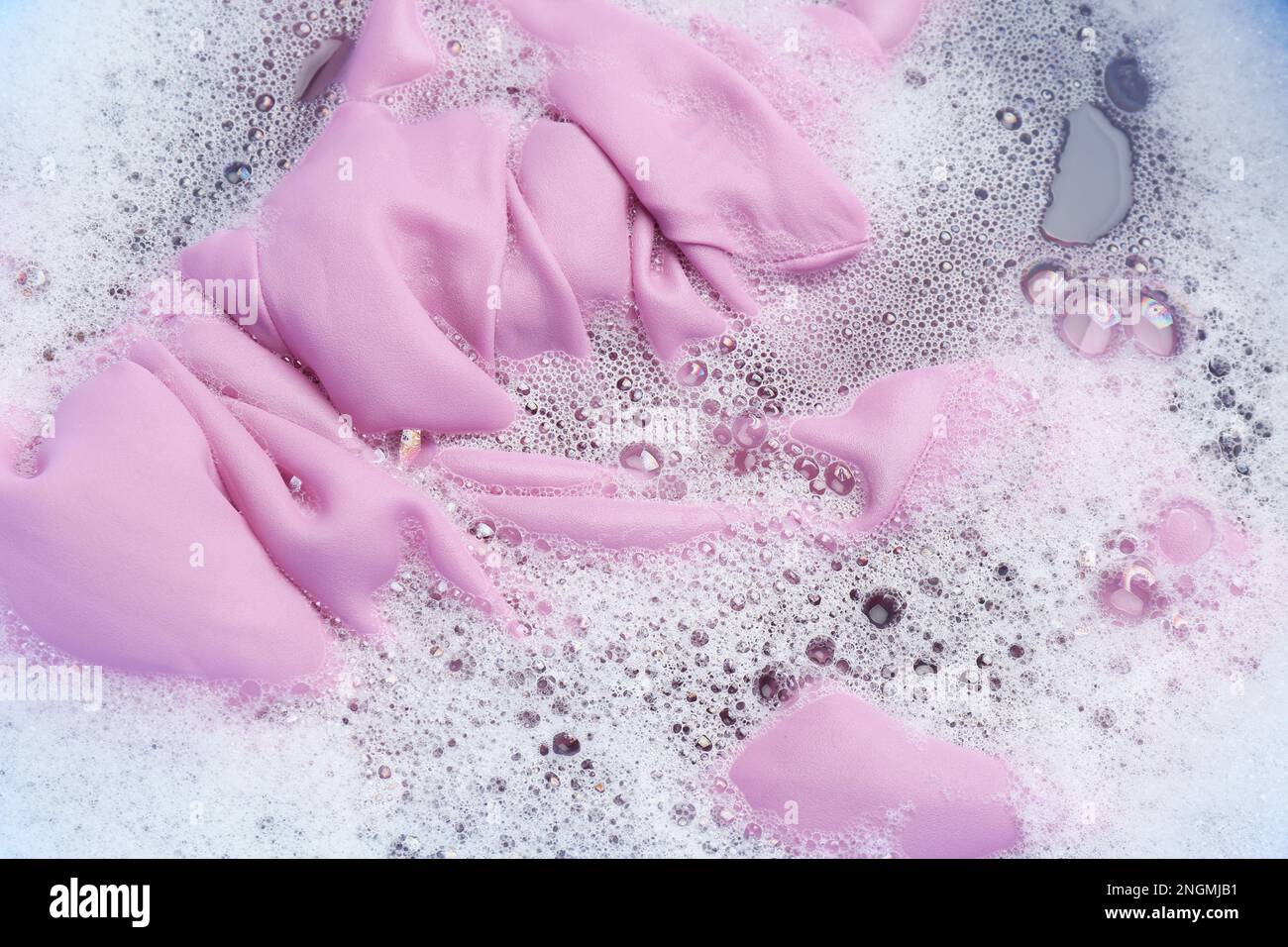 Color clothing in suds, top view. Hand washing laundry Stock Photo - Alamy