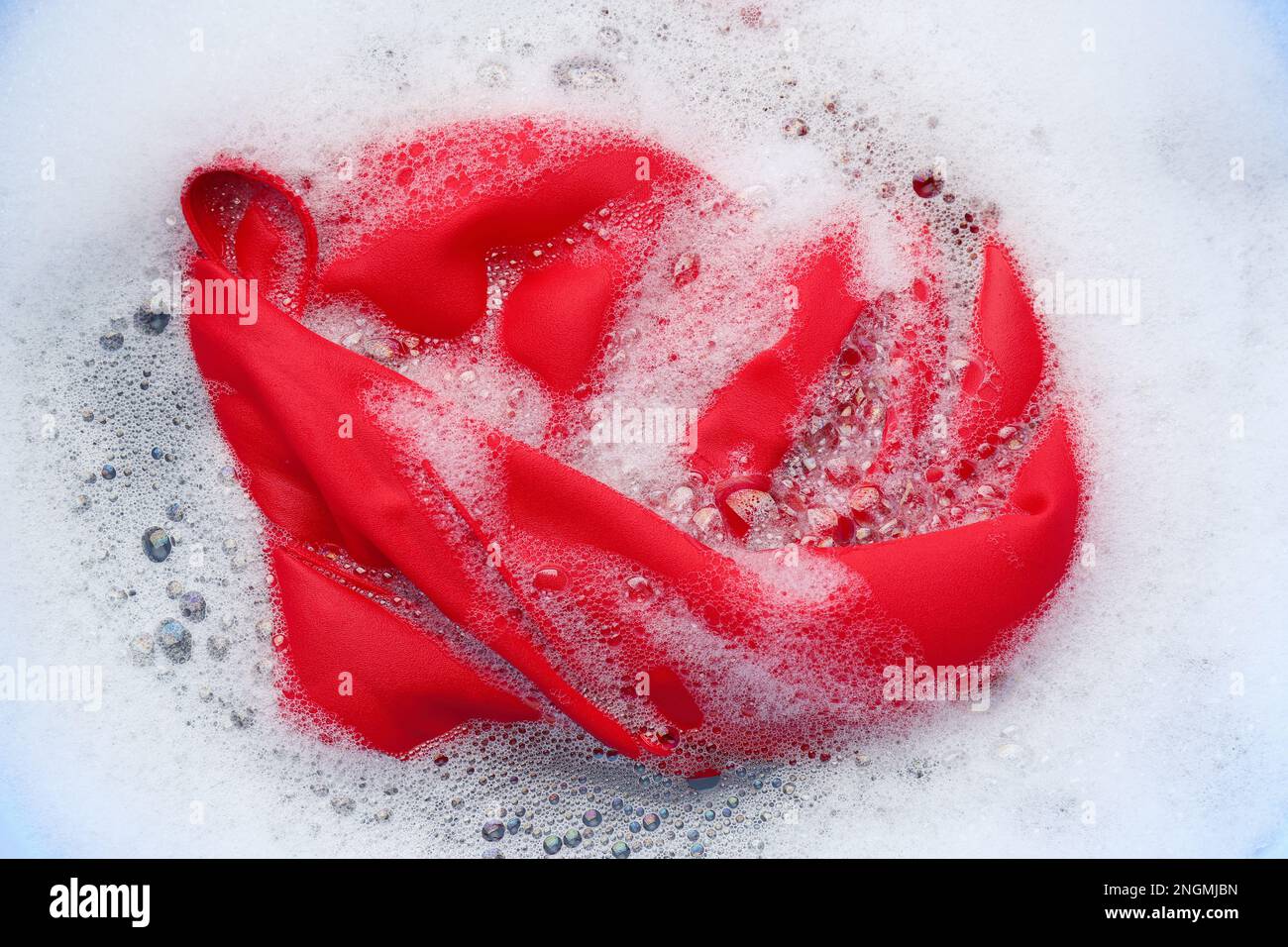 Color clothing in suds, top view. Hand washing laundry Stock Photo - Alamy