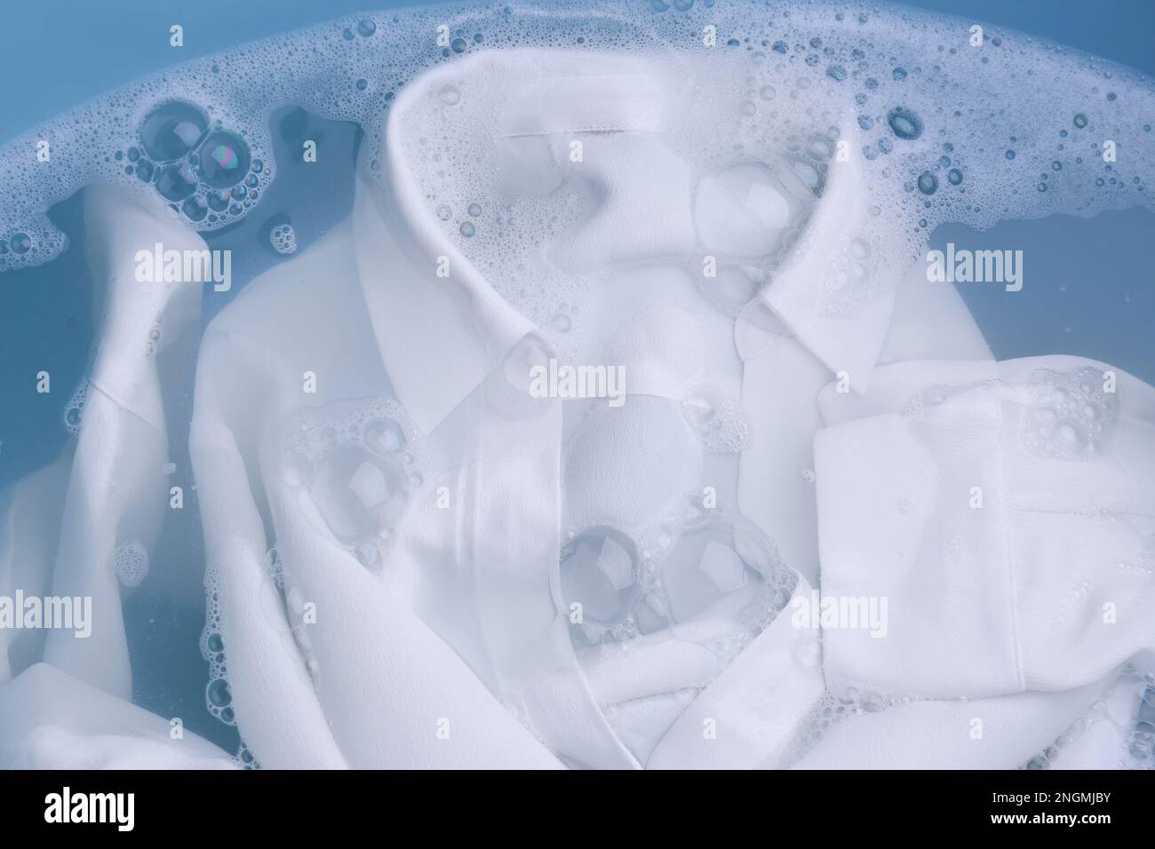 White clothing in suds, top view. Hand washing laundry Stock Photo - Alamy