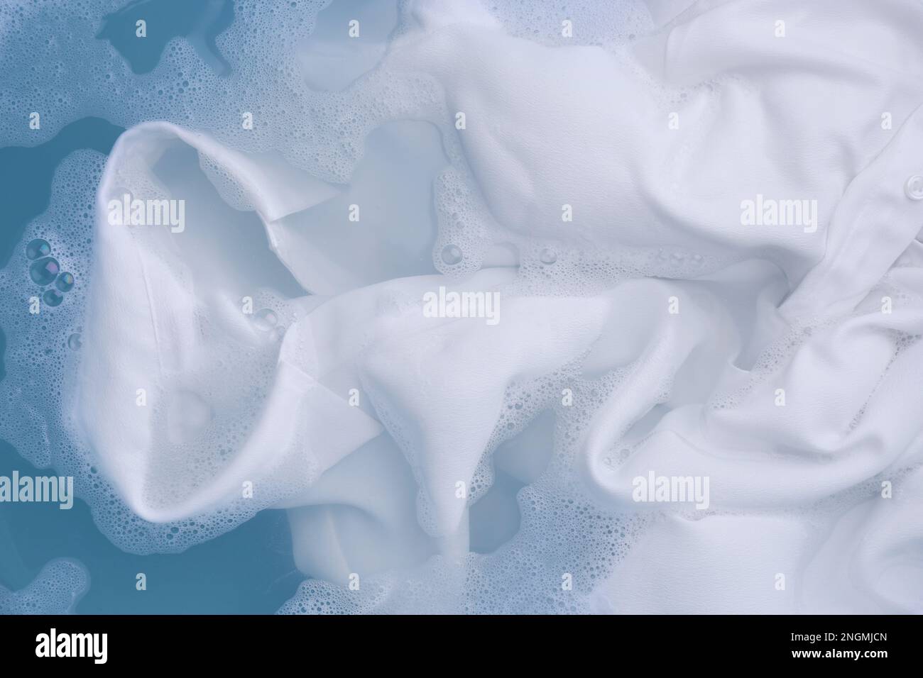 White clothing in suds, top view. Hand washing laundry Stock Photo - Alamy