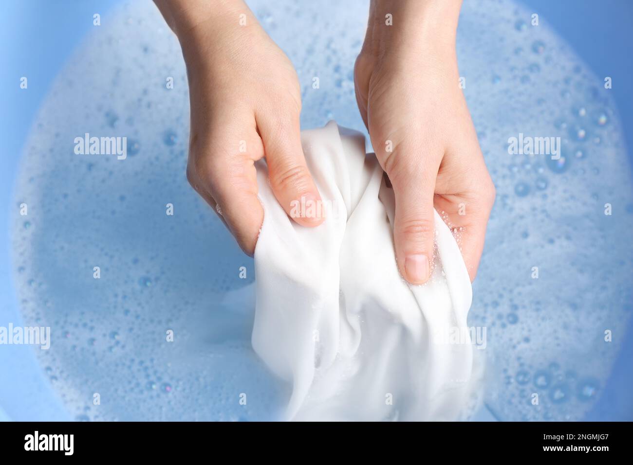 Top view of woman hand washing white clothing in suds, closeup Stock ...