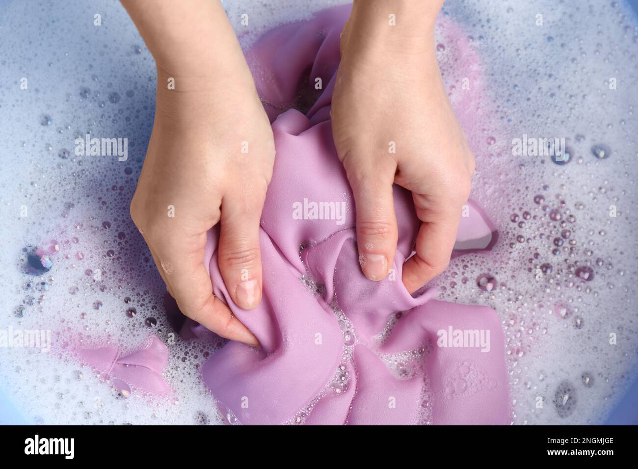Top view of woman hand washing color clothing in suds, closeup Stock ...