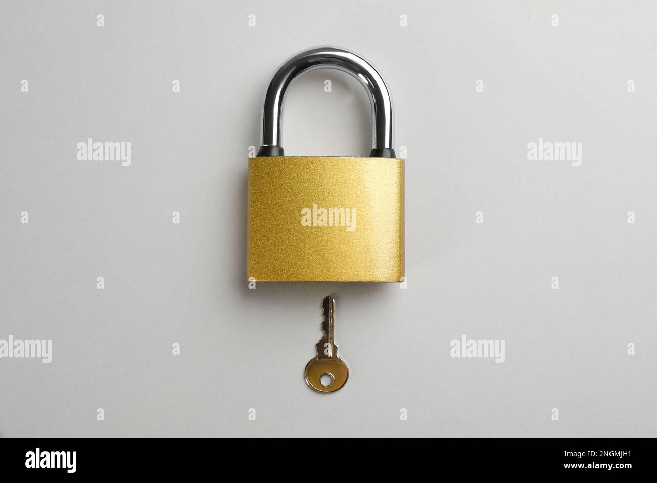 Modern padlock with key on light background, flat lay Stock Photo - Alamy