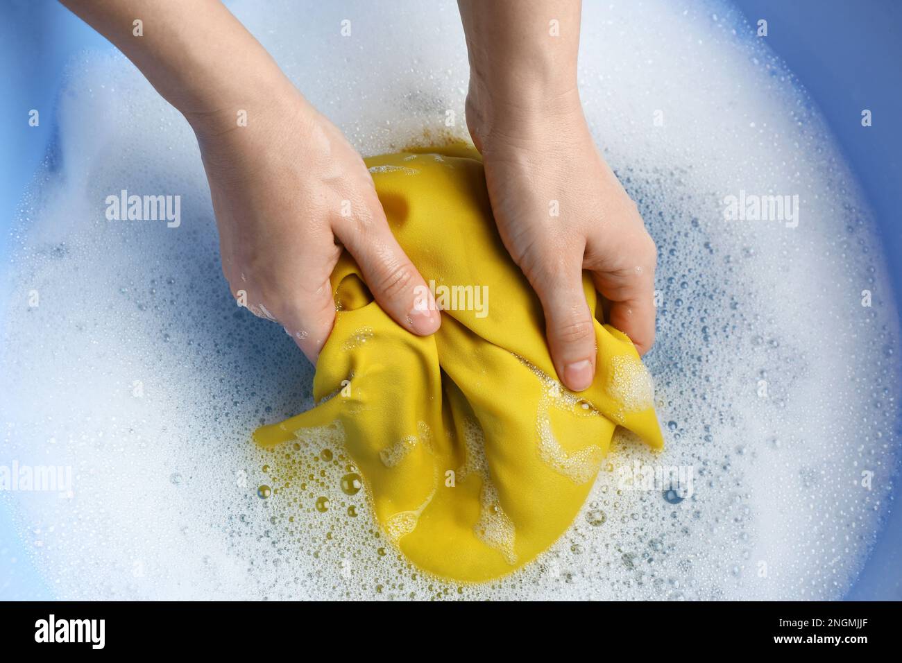 Top view of woman hand washing color clothing in suds, closeup Stock ...
