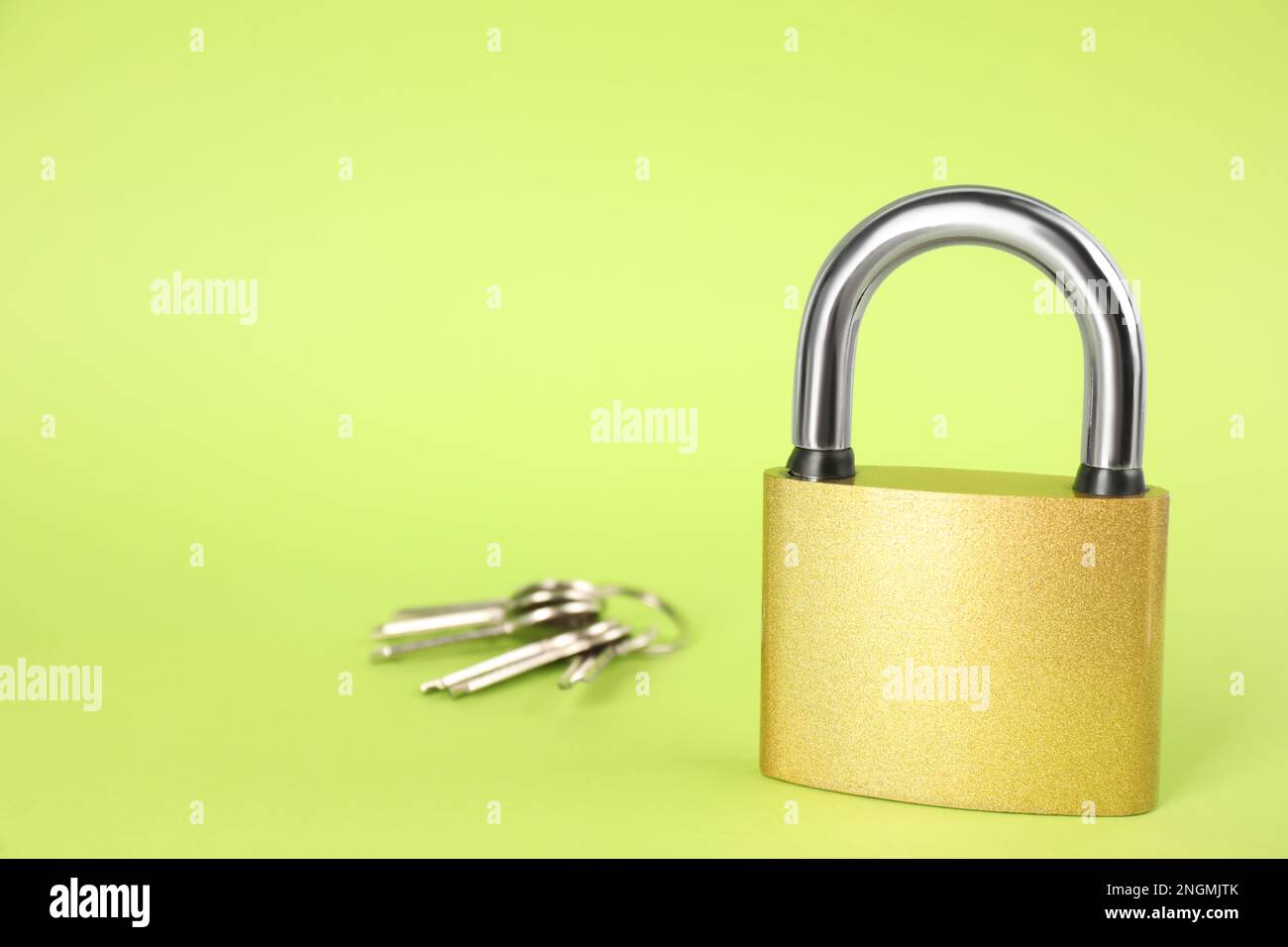 Modern padlock and keys on light green background. Space for text Stock ...