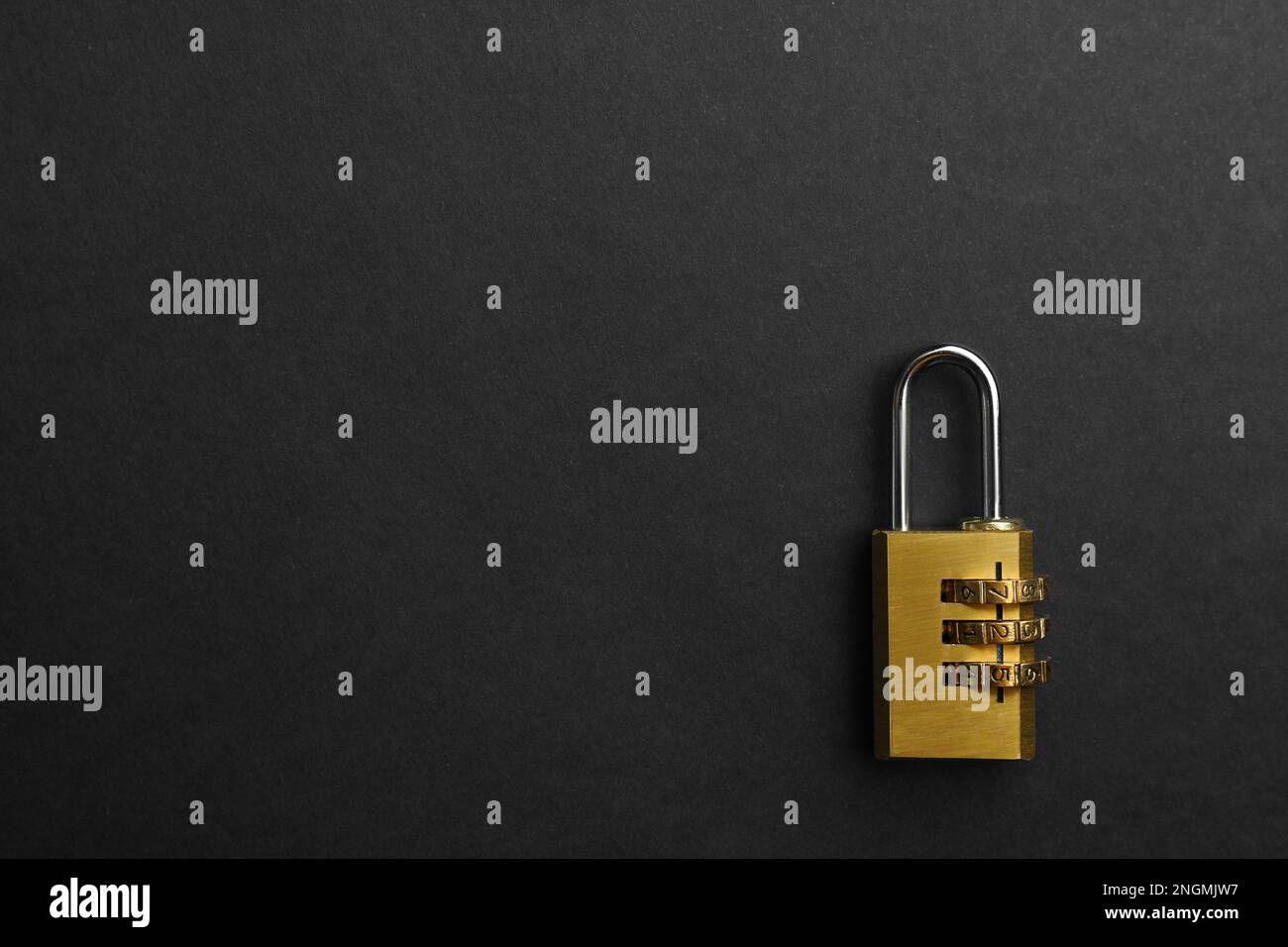 Modern combination lock on black background, top view. Space for text ...