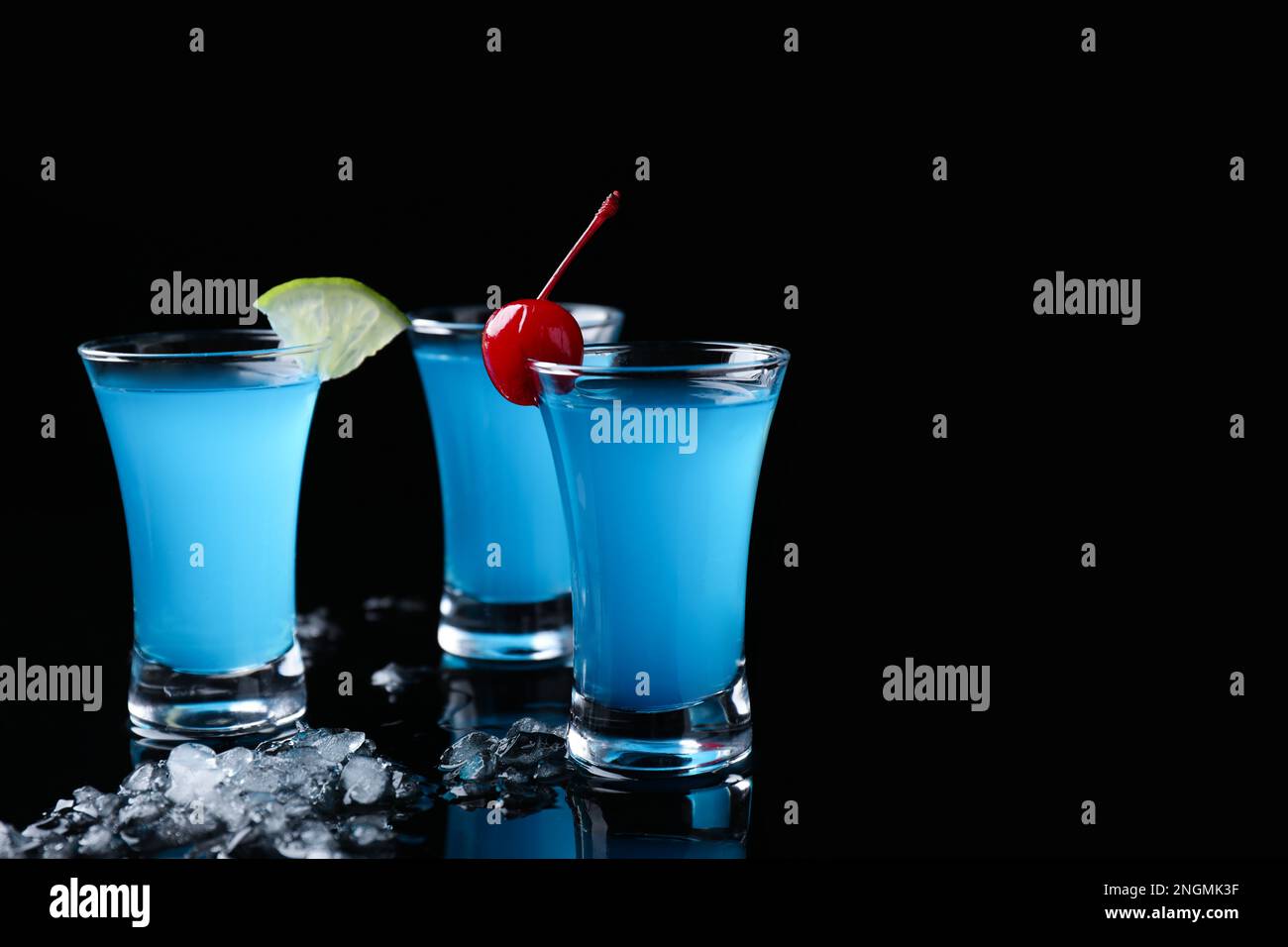 Bright light blue shots on black table, space for text Stock Photo - Alamy