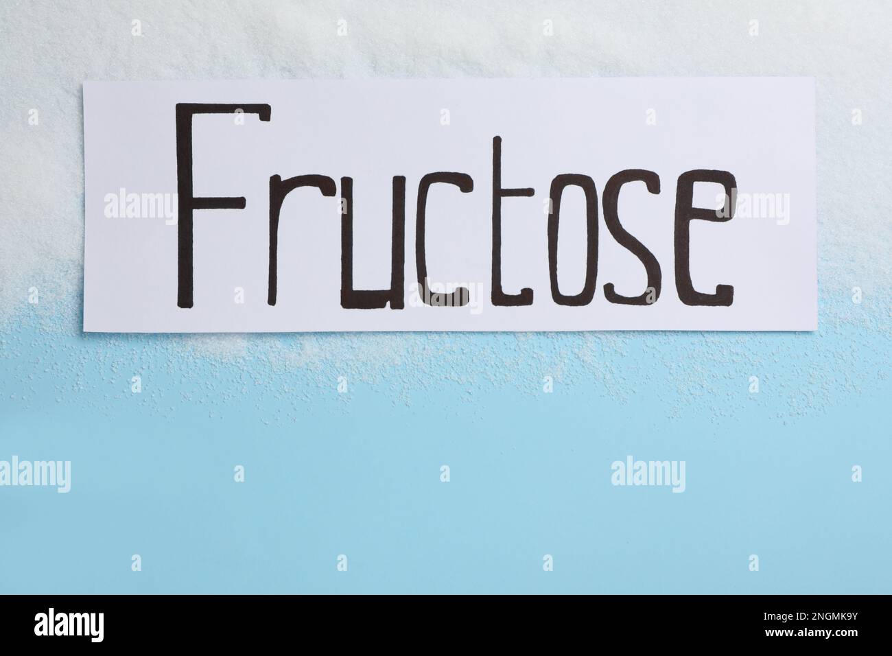 Paper with word Fructose and sugar on light blue background, flat lay ...