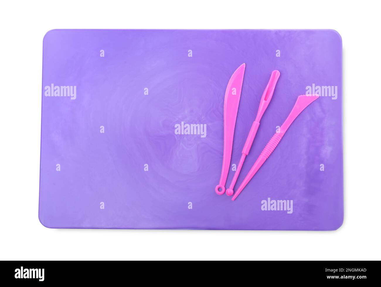 Purple board with tools for plasticine on white background, top view ...