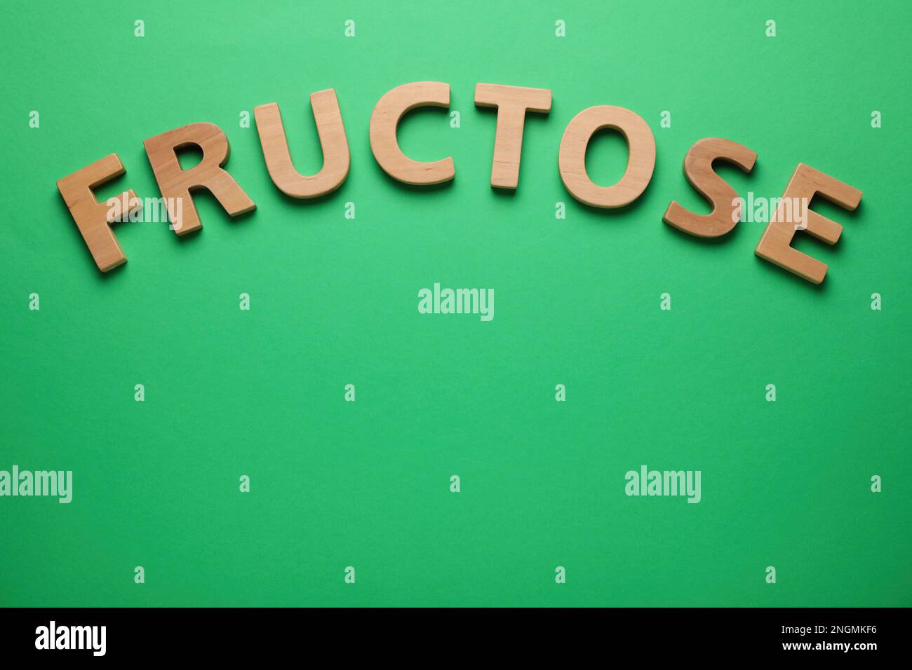 Word Fructose made of wooden letters on green background, flat lay ...