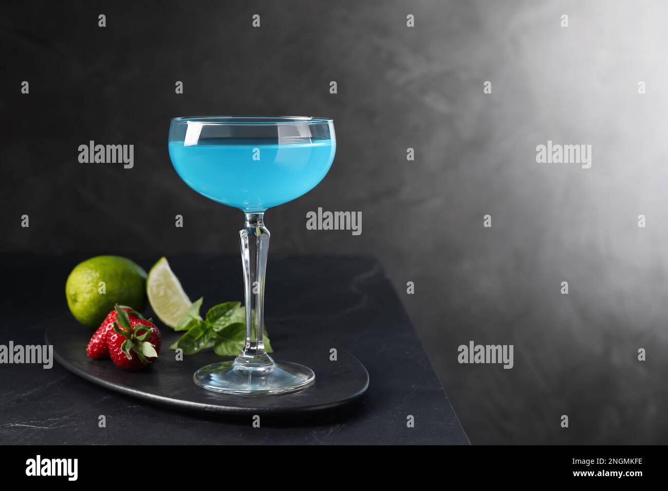 Light blue cocktail served on dark table, space for text Stock Photo ...