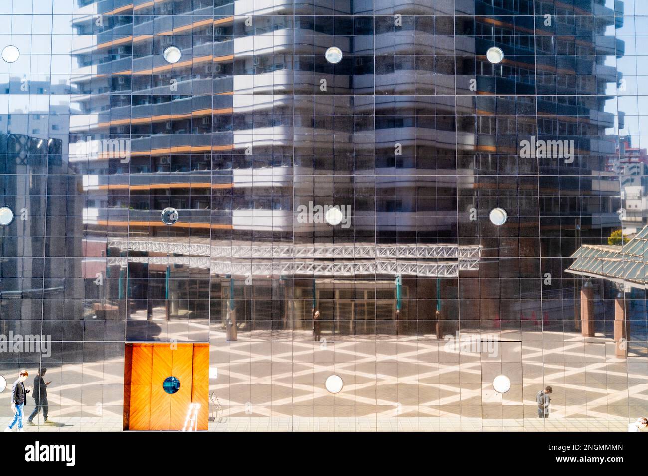 Tokyo, Asahi Beer Hall building. Wooden door entrance in black glassed ...