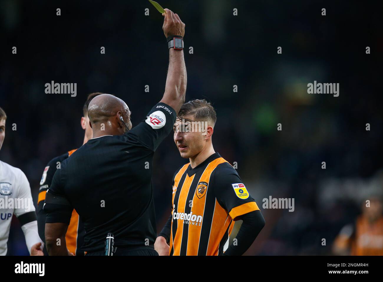 The referee Referee Sam Allison issues a yellow card to Dimitrios ...