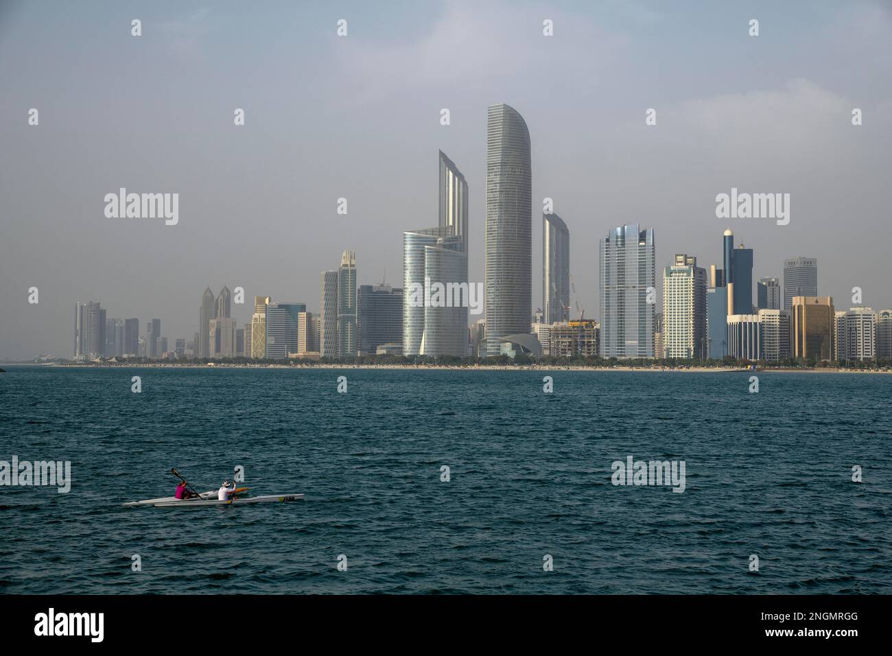Sea kayak in front of smog skyline, Abu Dhabi, Emirate of Abu Dhabi ...