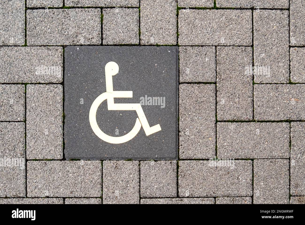 Pictogram disabled parking space on paving stones Stock Photo - Alamy