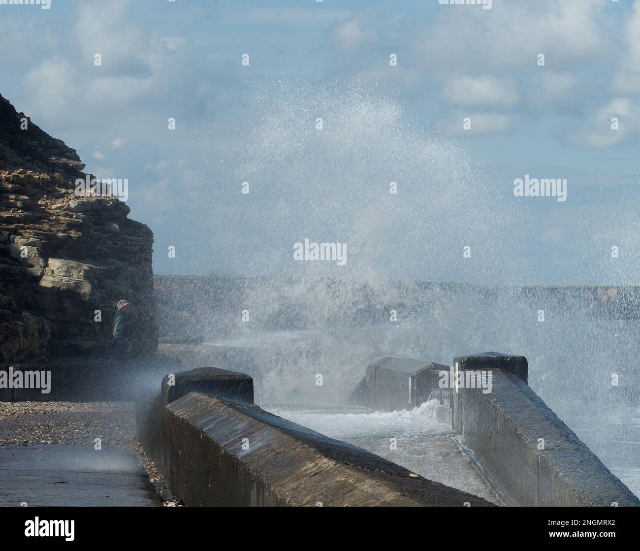 Heavy seas crash into promenade creating great columns of sea spray ...