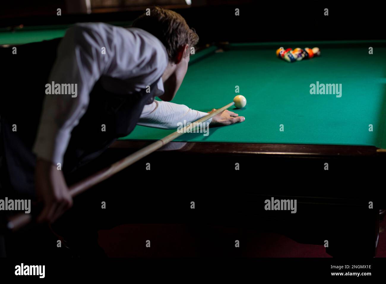 medium shot guy holding pool cue Stock Photo - Alamy