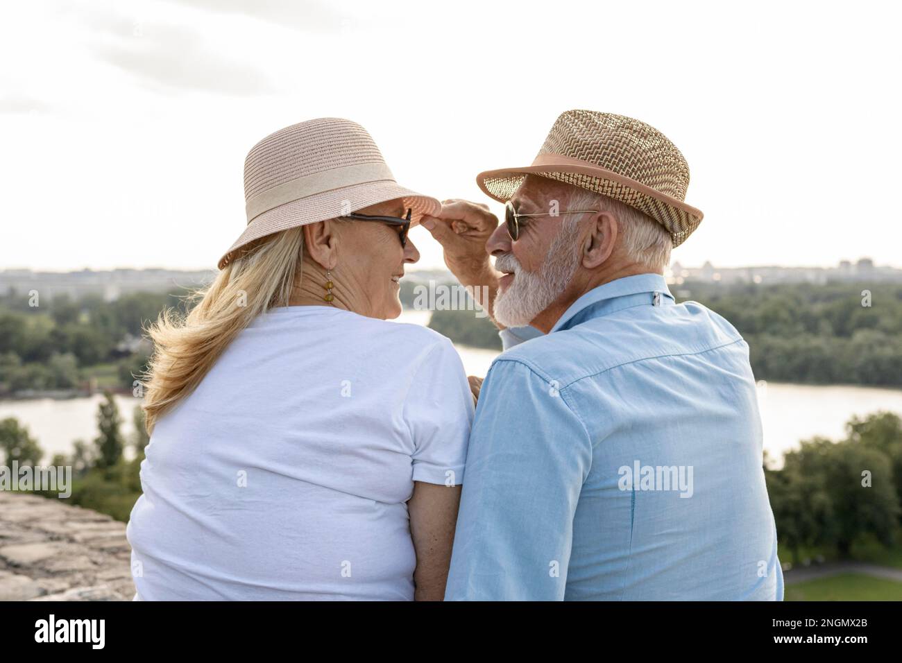 old man grabbing woman s hat Stock Photo - Alamy